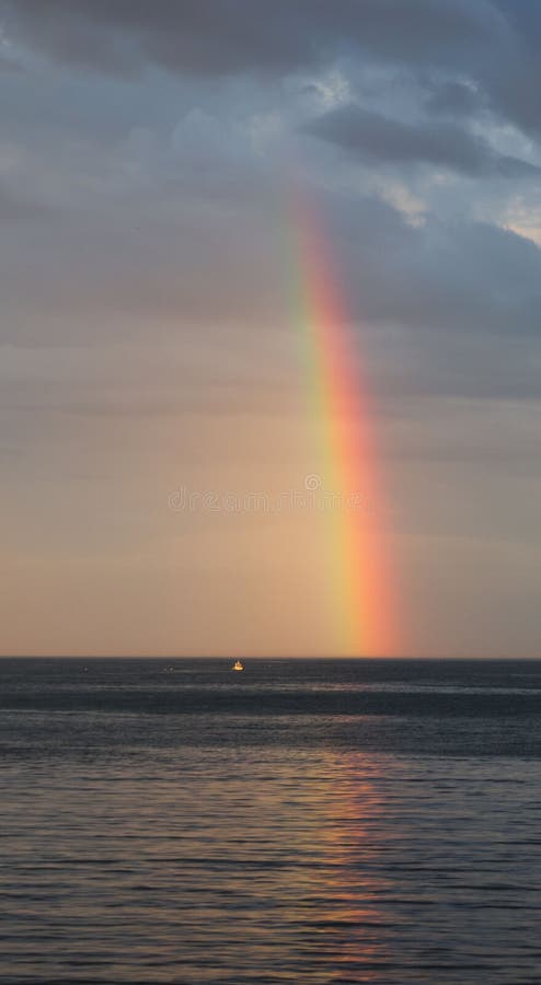 Rainbow Over Ocean at Sunset Stock Photo - Image of stormy, sunset ...