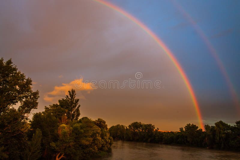 A rainbow over the river stock photo. Image of countryside - 37417716