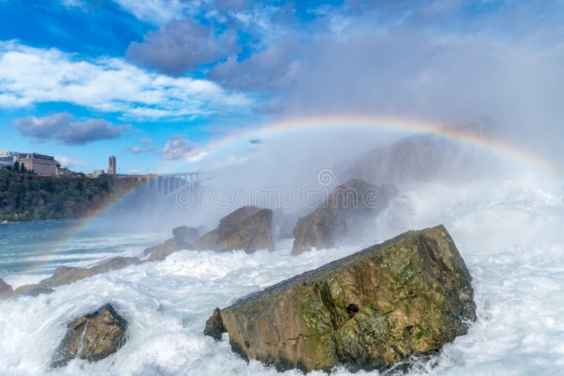 Rainbow over the river editorial photo. Image of rainbow - 147943871