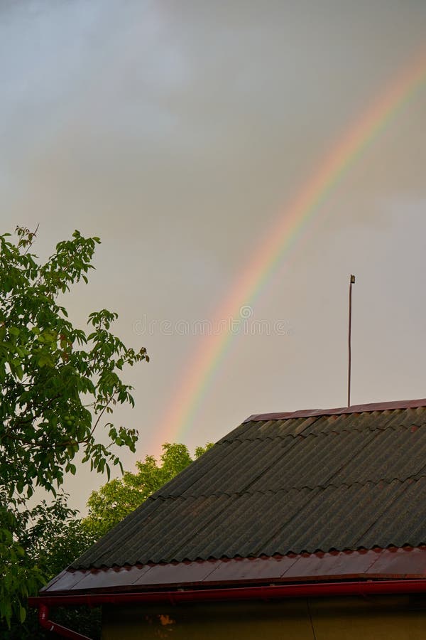 Rainbow Over the House,Rainy Weather, Clouds, Rainbow, and a Wet Roof ...