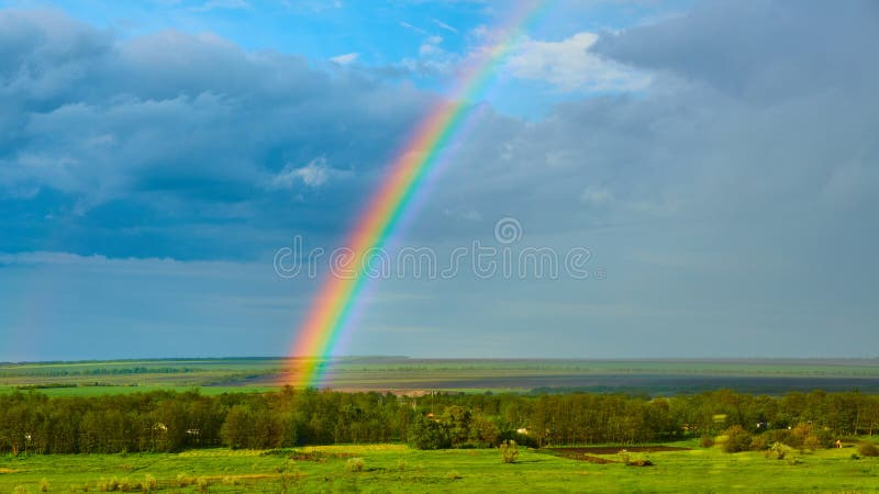 The Rainbow Over Rural Landscape after Thunderstorm. Stock Image ...