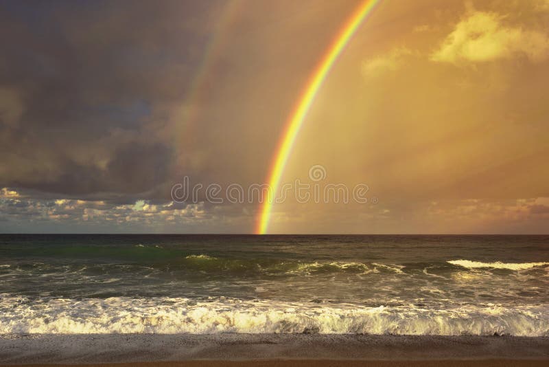 Rainbow Over the Sea and Tropical Beach with Umbrellas Chairs and ...