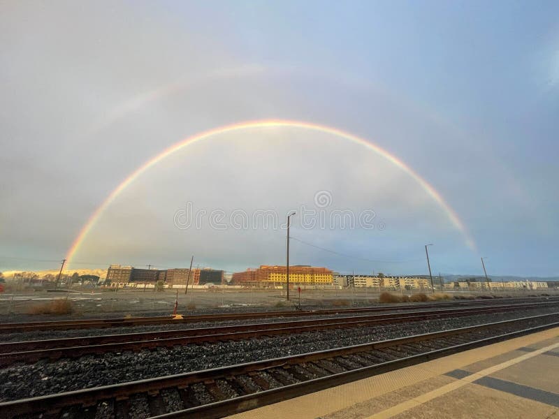 A Rainbow Appears To Be in the Middle of a Train Track Stock Photo ...
