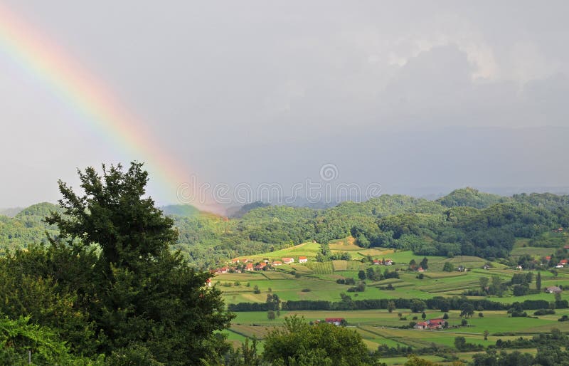 Rainbow over the valley stock image. Image of green, clouds - 53580849