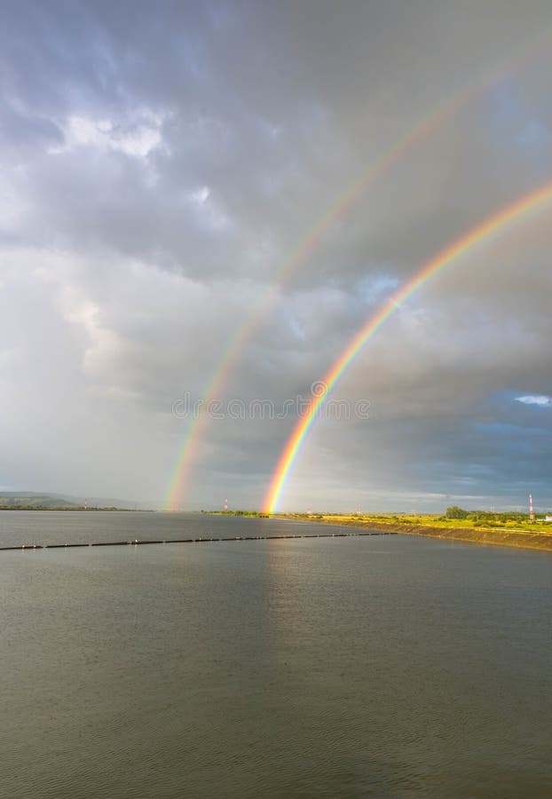 Rainbow over water stock image. Image of landscape, horizon - 96827453