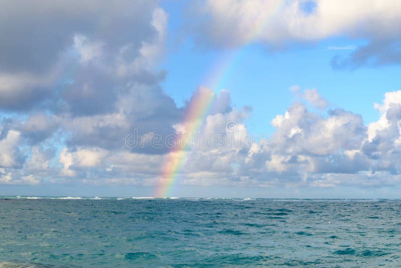 Rainbow over water stock image. Image of paradise, sunny - 169128609