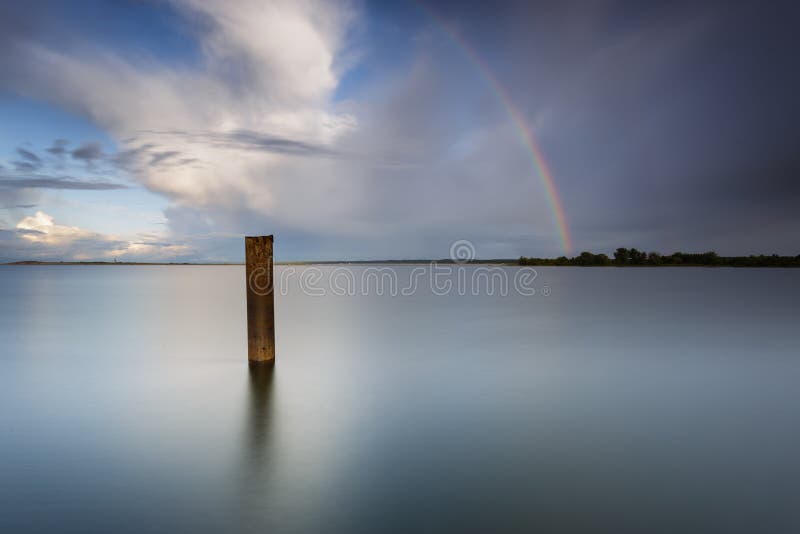 Rainbow over the water stock photo. Image of landscape - 102127874