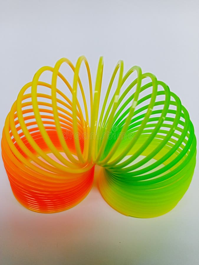 Rainbow Plastic Coil Spring Toy on White Background Stock Image - Image ...