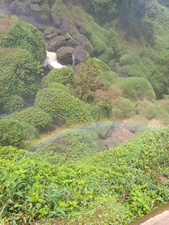 A Rainbow Produced by a Waterfall Carried by the Wind Stock Image ...