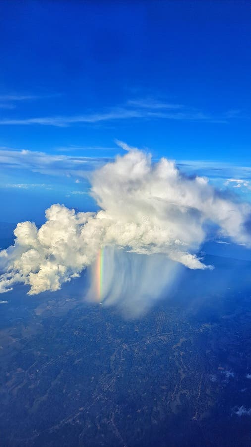 Rainbow Rain Shower, a Vibrant Rainbow Emerging from a Rain Cloud Over ...