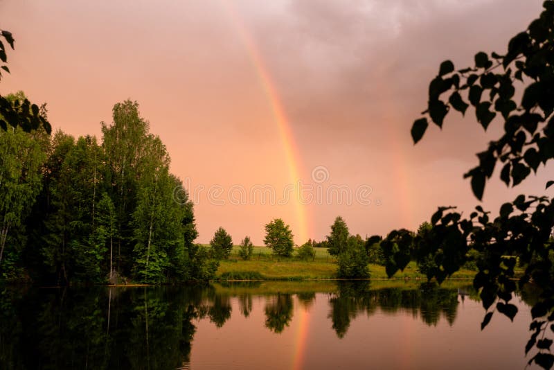 Rainbow and Red-yellow Sunset with Reflection in a Forest Pond. Stock ...