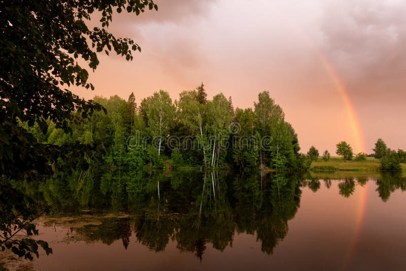 Rainbow and Red-yellow Sunset with Reflection in a Forest Pond. Stock ...