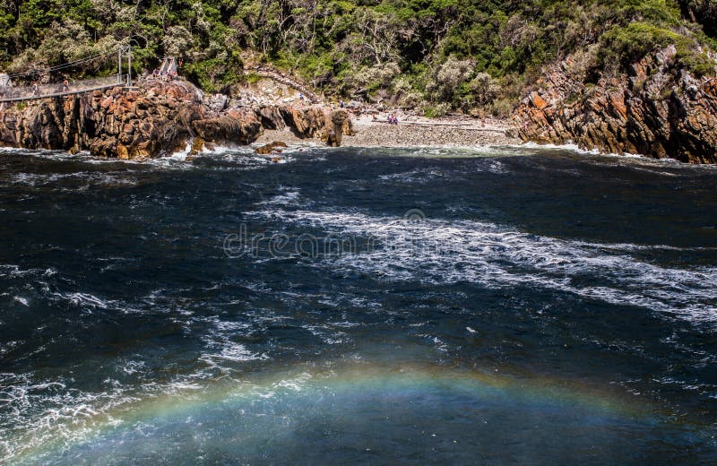 Rainbow Reflecting on the River Surrounded by Rocks and Greenery Under ...