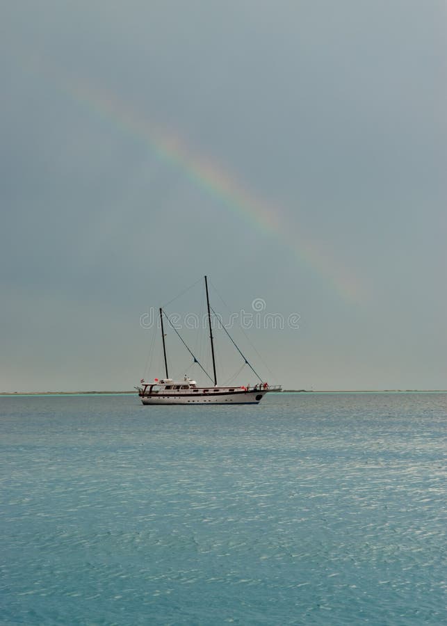 Rainbow with Sailing Boat on a Flat Sea Stock Image - Image of helps ...