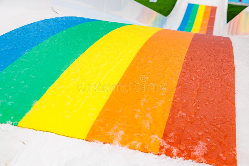 A Rainbow Slide with a Rainbow Stripe on it Stock Image - Image of ...