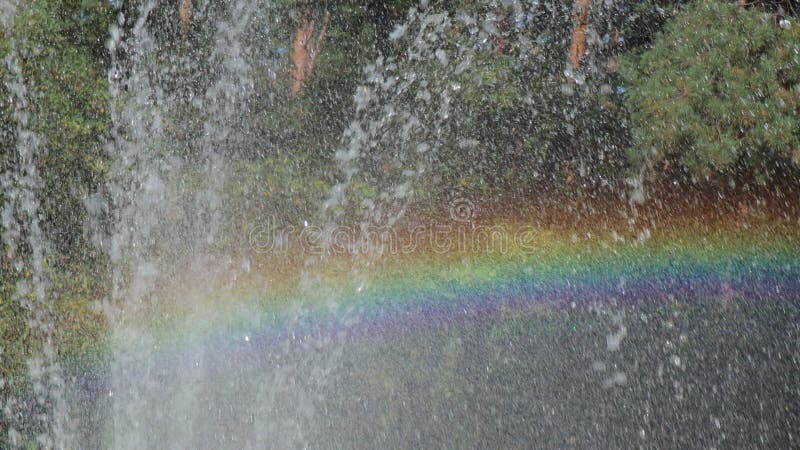 Rainbow in the Spray of the Fountain. Flying Water Drops on a Sunny Day ...