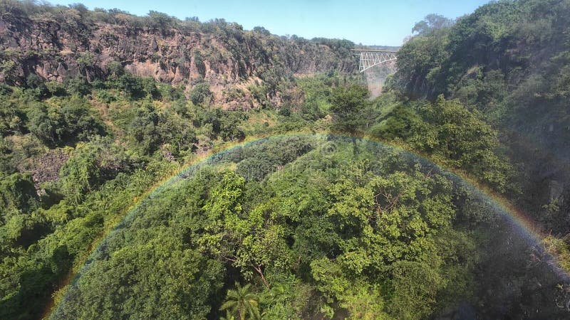 Rainbow with Spray on a Sunny Day with a Background of Victoria Falls ...