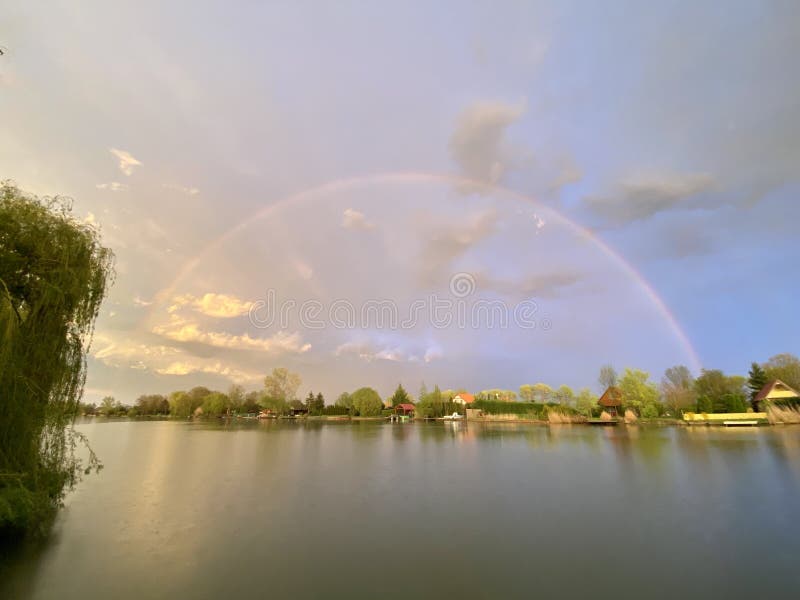 Rainbow stock image. Image of sunset, houses, water - 246103079