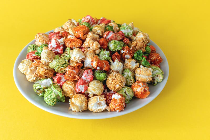 A Rainbow of Sweet Popcorn in a Plate on a Green Background, Close Up ...
