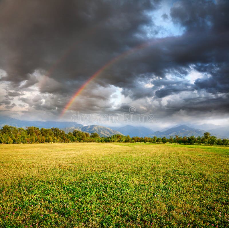 Rainbow under Grass field stock photo. Image of land - 21227894