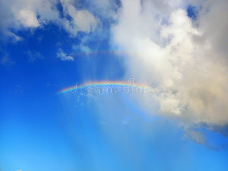 Rainbow between White Clouds and Tropical Blue Sky. Spectacular Sky ...