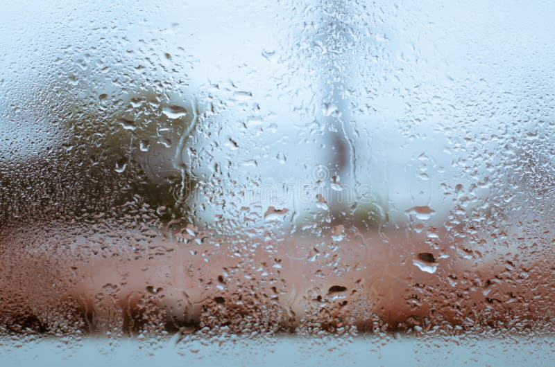Raindrop Falling on the Window Glass in Blurry Background. Stock Photo ...