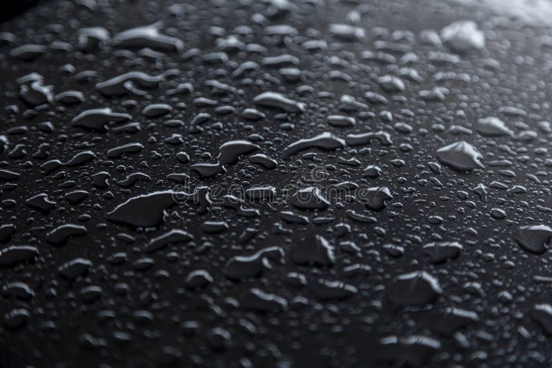 Raindrops on a Black Object with the Light Shining To Create a ...
