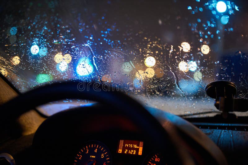 Raindrops on a Car Windshield with Blurred Colorful City Lights at ...