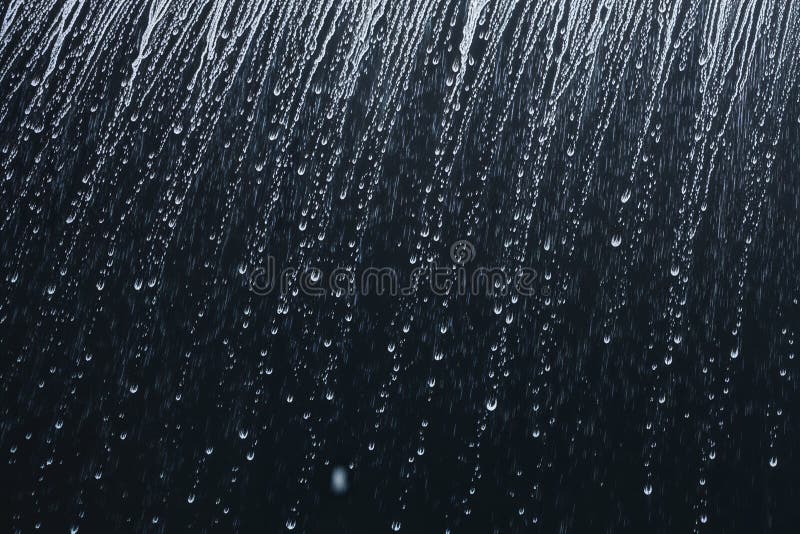 Raindrops Cascade Down a Dark Surface during a Heavy Rainstorm Stock ...