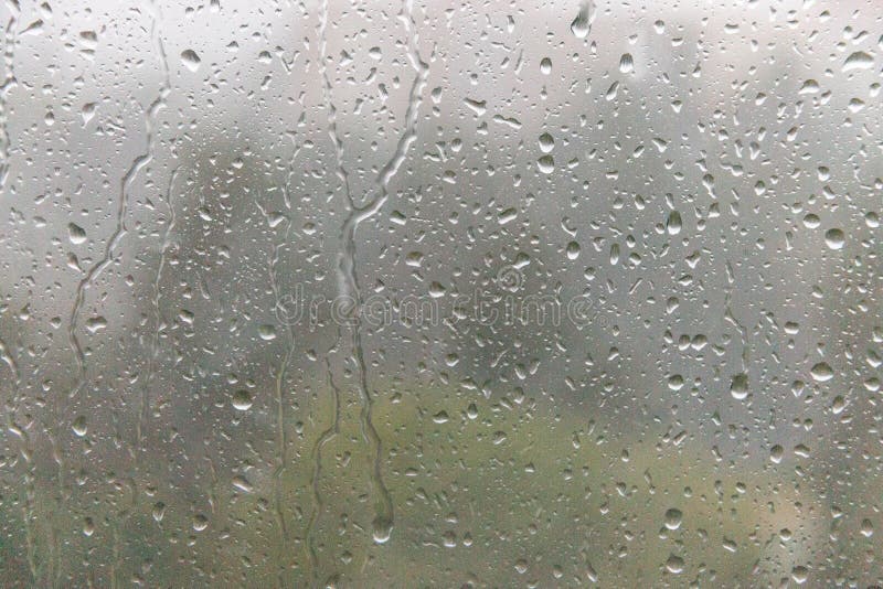 Raindrops Drip Down on the Window Glass. Soft Selective Focus Stock ...