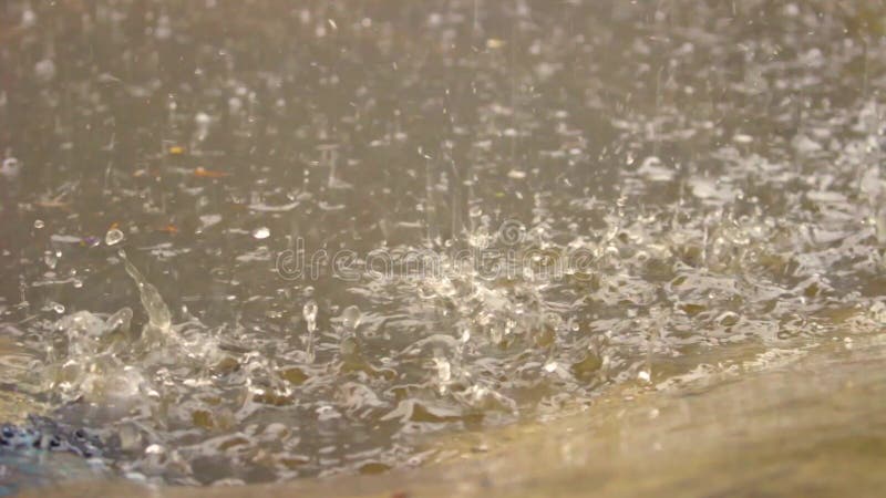 The Raindrops Dripping into the Puddle in Front of the House Stock ...