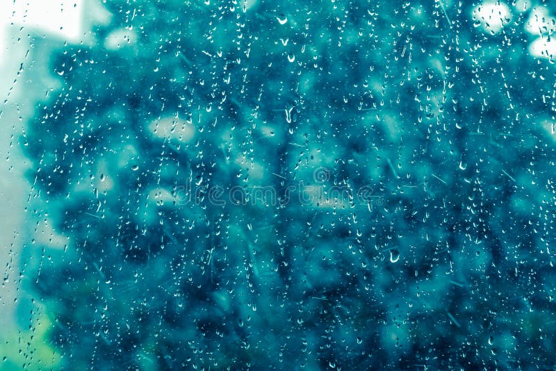 Drops Falling on Glass. Turquoise Blurred Background. Stock Image ...