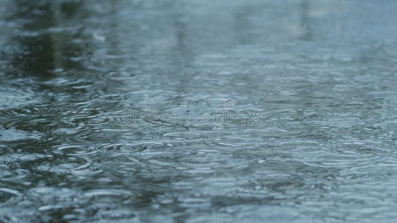 Raindrops Falling on the Smooth Surface of the Pool. Stock Footage ...