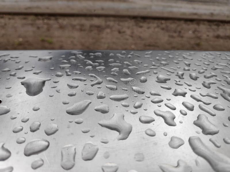 Raindrops Form Shapes on Metal Stock Photo - Image of liquid, aqua ...