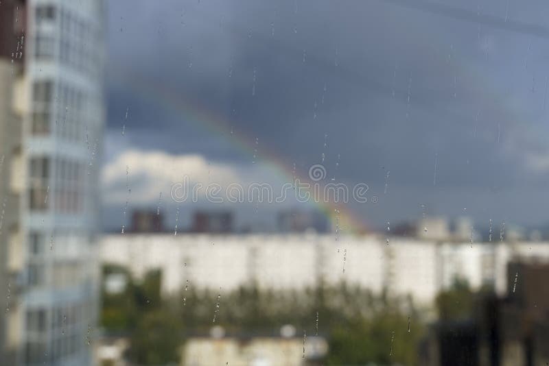 Raindrops on the Glass and a Rainbow Outside the Window, the Sun during ...