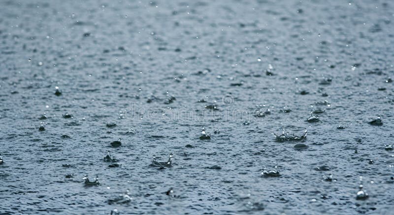 Raindrops Impacting Water Surface: a Detailed View of Rainfall Stock ...