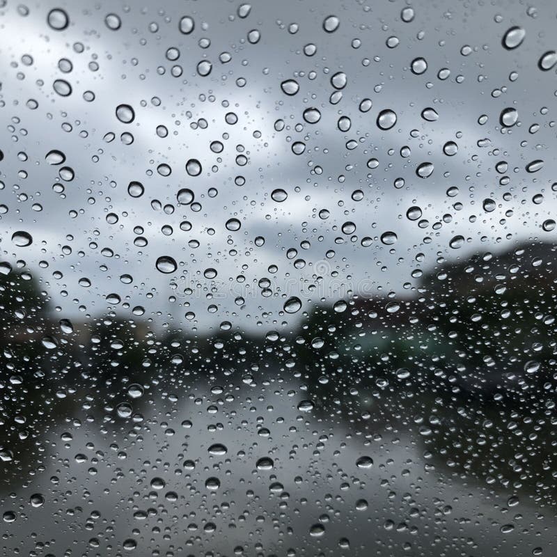 Raindrops Scatter Across a Transparent Surface, Blurring the View ...