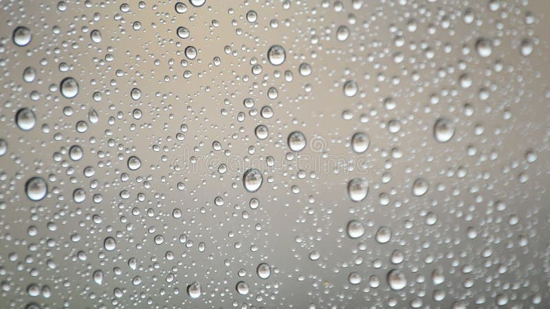 Raindrops Sliding on Window Glass Blurring Houses in the Background ...