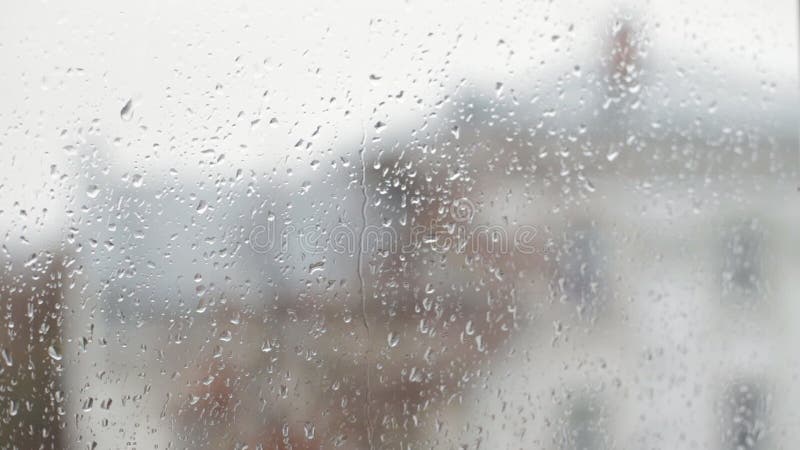 Raindrops Sliding on Window Glass Reflecting Building during Rainy Day ...
