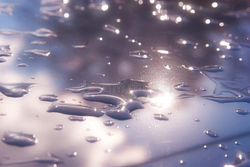 Raindrops, Sun Glare and Reflection of the Sky on Metal Surface Stock ...