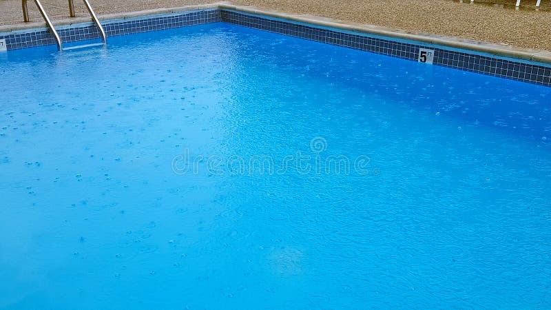 Raindrops on swimming pool stock image. Image of splash - 78083295
