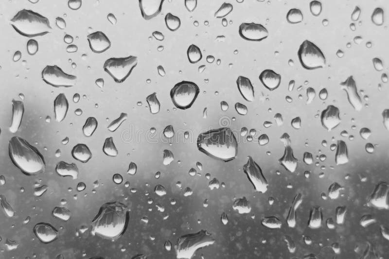 Raindrops on a Window Glass with a Blurred Gray Sky in the Background ...