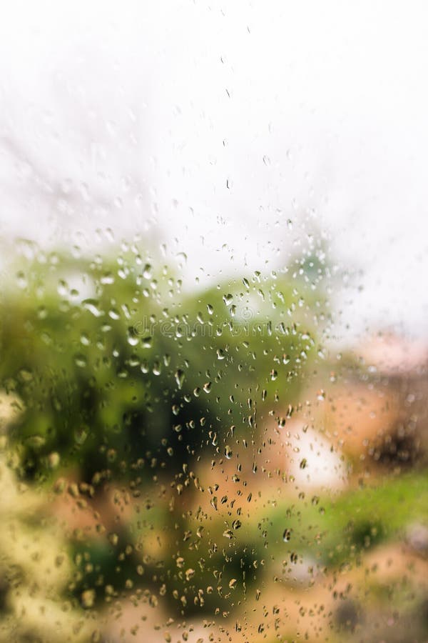 Raindrops on the Window with Out of Focus Backyard Bokeh during a Cold ...