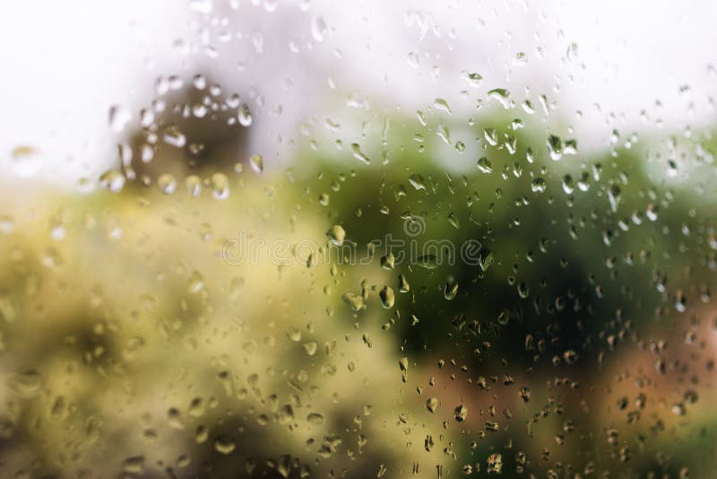 Raindrops on the Window with Out of Focus Backyard Bokeh during a Cold ...