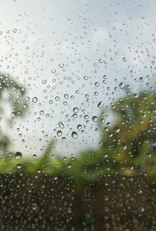 Raindrops on Windows with Blurry Green View in Background Stock Photo ...