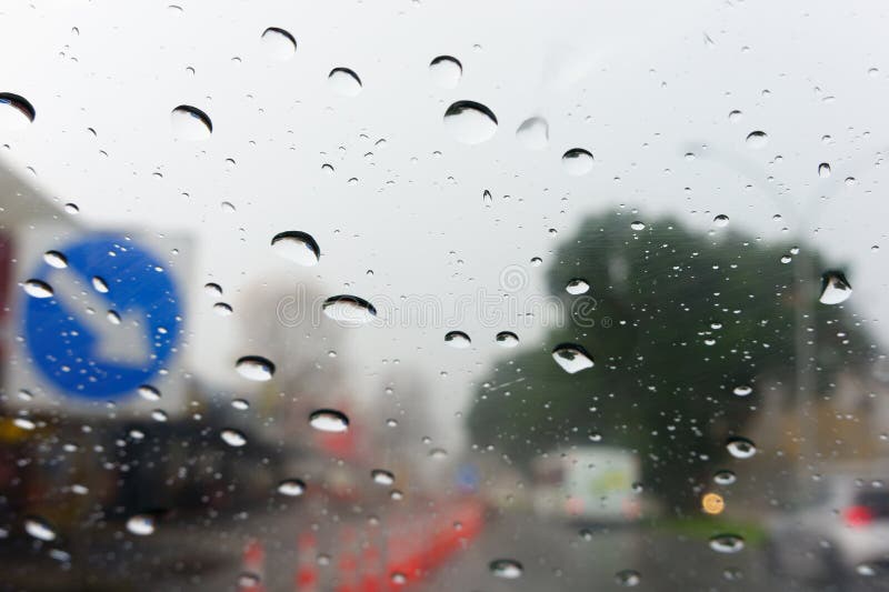Raindrops on Windscreen with Defocused Road of Street Cones and Signs ...