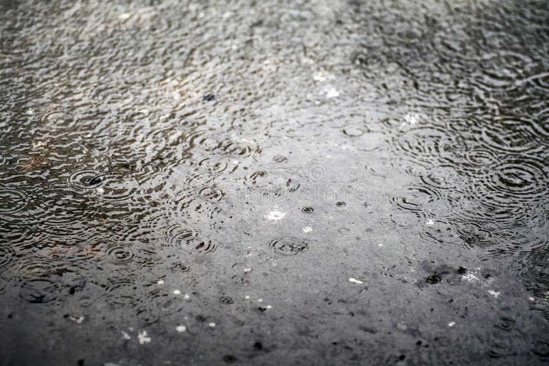 Raining on the Concrete Walk Way Full with Rain Droplets Splash Ring ...