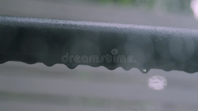 Camera Static through a Window on Raindrop Sticks on a Clothes Rack and ...