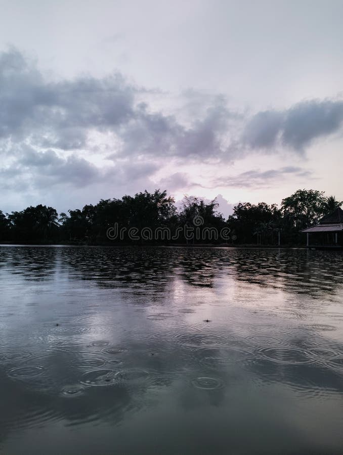 Raining lake sunset stock image. Image of lake, sunset - 274668649