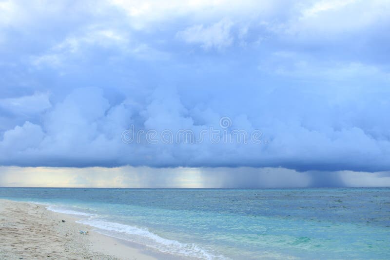Raining in middle of ocean stock photo. Image of island - 353314726